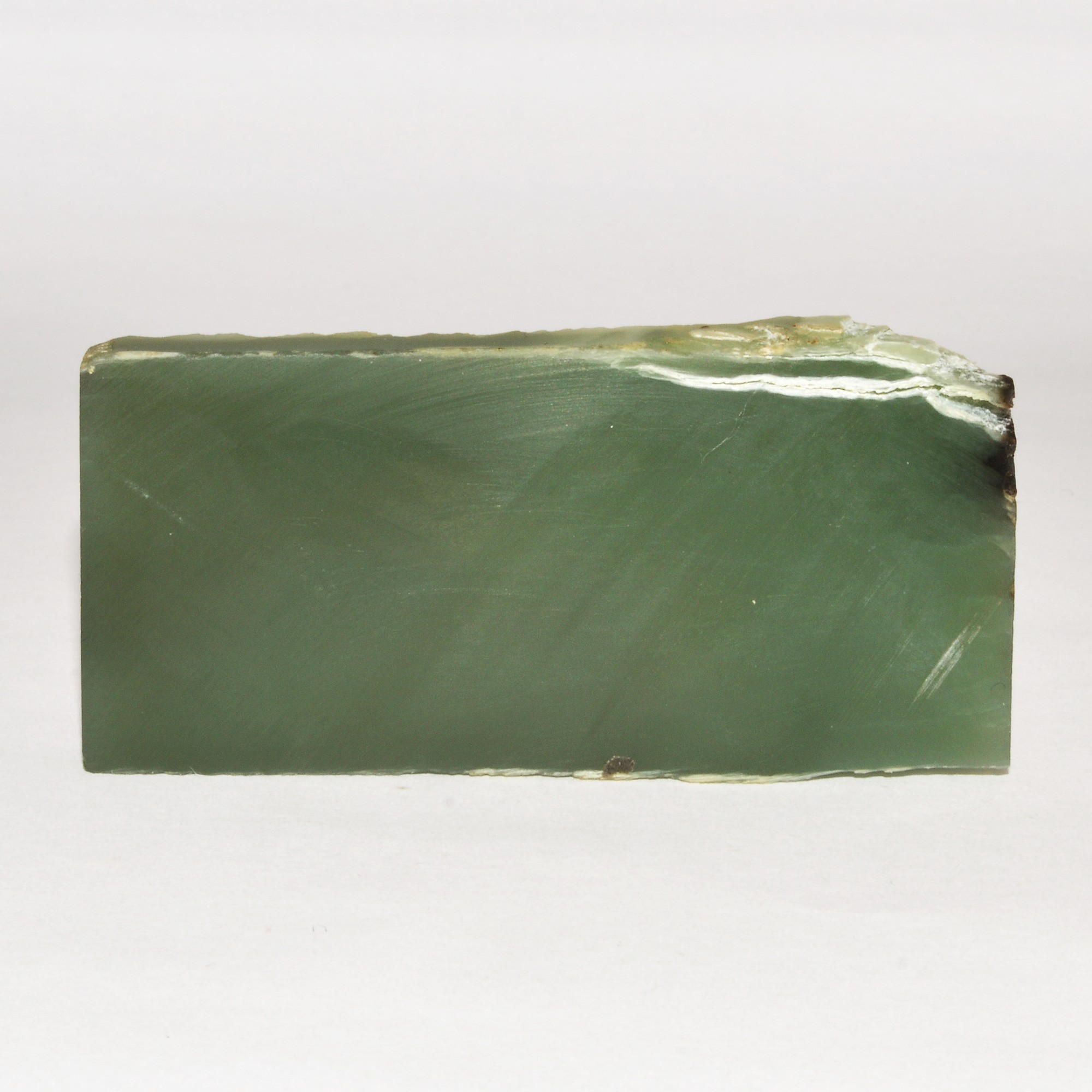 Polished on one side is a plate of uniform greenish-gray jad | Inspire ...